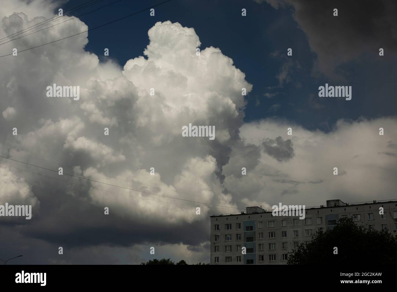 White cloud in summer. Changing weather. A storm cloud over the city ...