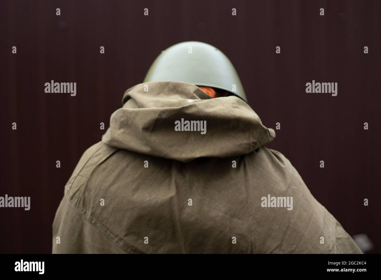 A soldier in a helmet from the back. Old Soviet military uniform. A ...