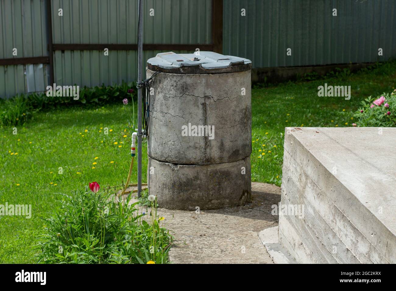 A well with water. A well on the land. Water supply from deep layers of ...