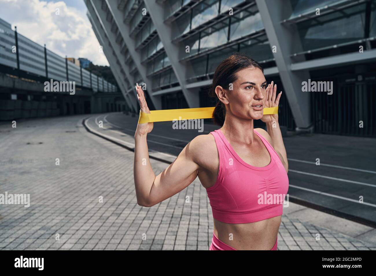 Female spreading arms with resistance band to sides Stock Photo - Alamy