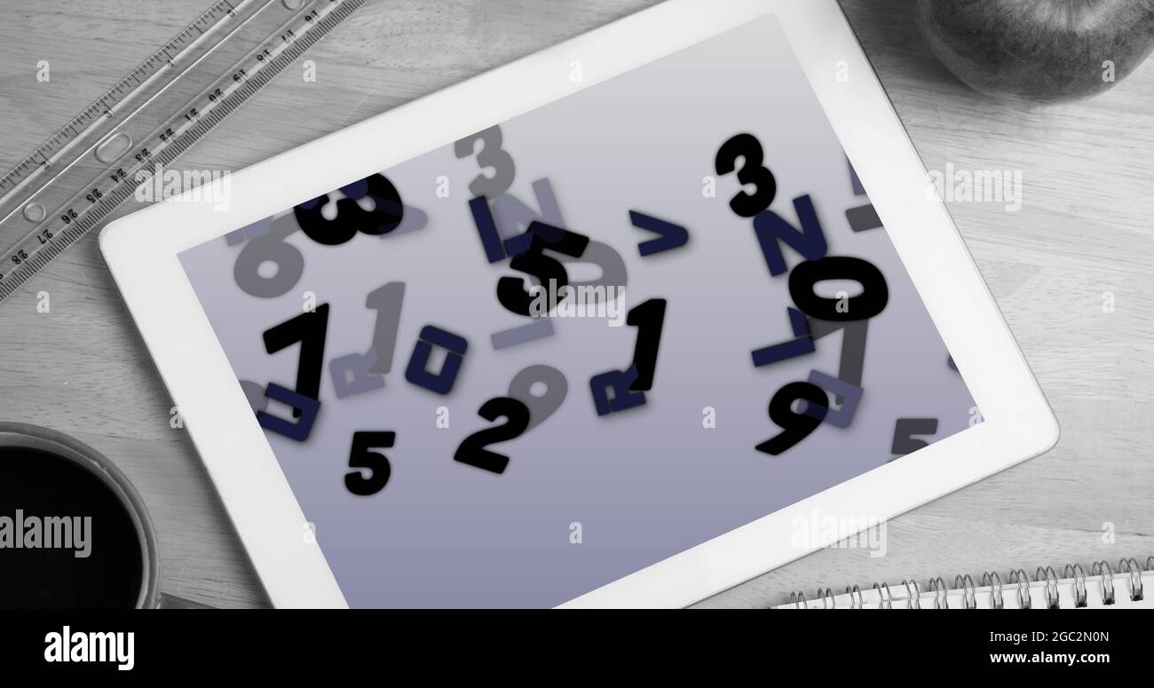 Digital image of multiple numbers and alphabets on screen on digital tablet on wooden surface ...