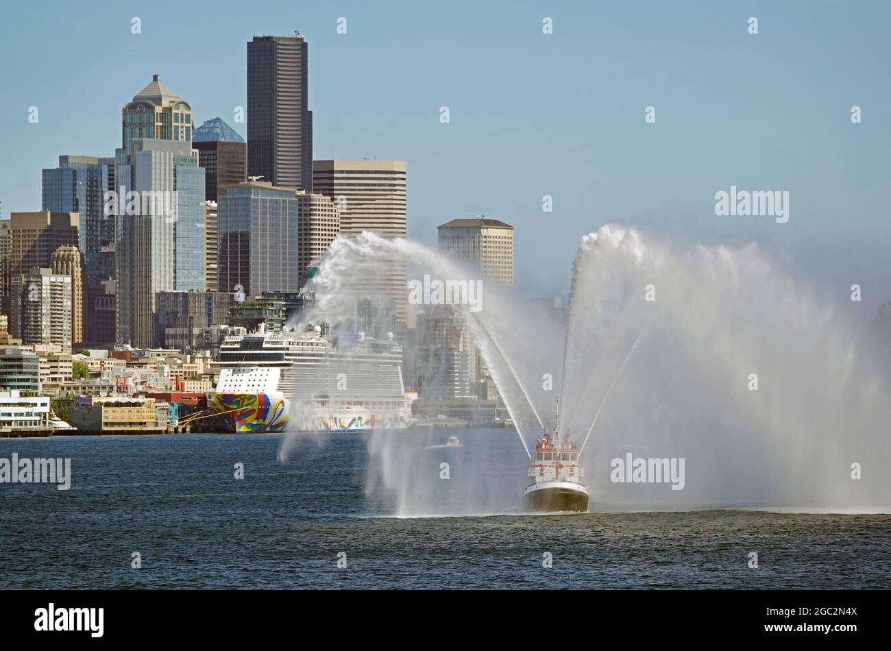Seattle, Washington Harbor, Puget Sound, 2021. A fireboat shows off its ...