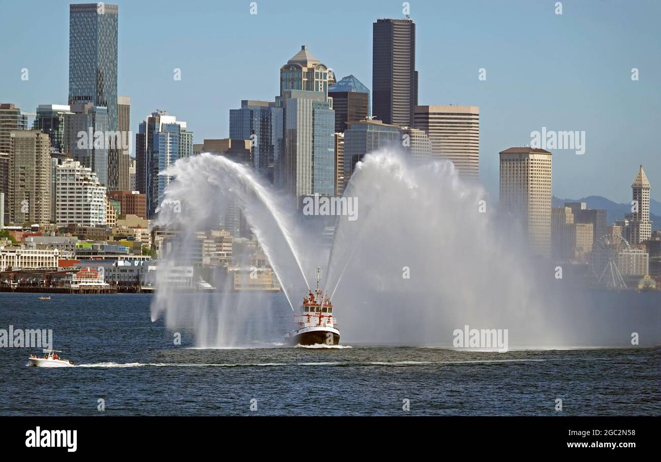 Seattle, Washington Harbor, Puget Sound, 2021. A fireboat shows off its ...