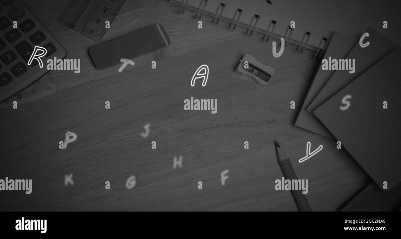Multiple english alphabets floating against school stationary items on ...
