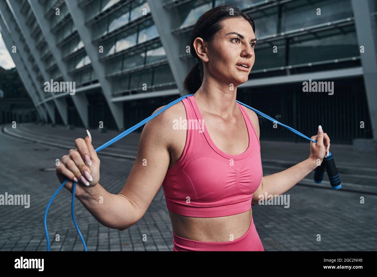Female wrapping jumping rope over her neck Stock Photo - Alamy