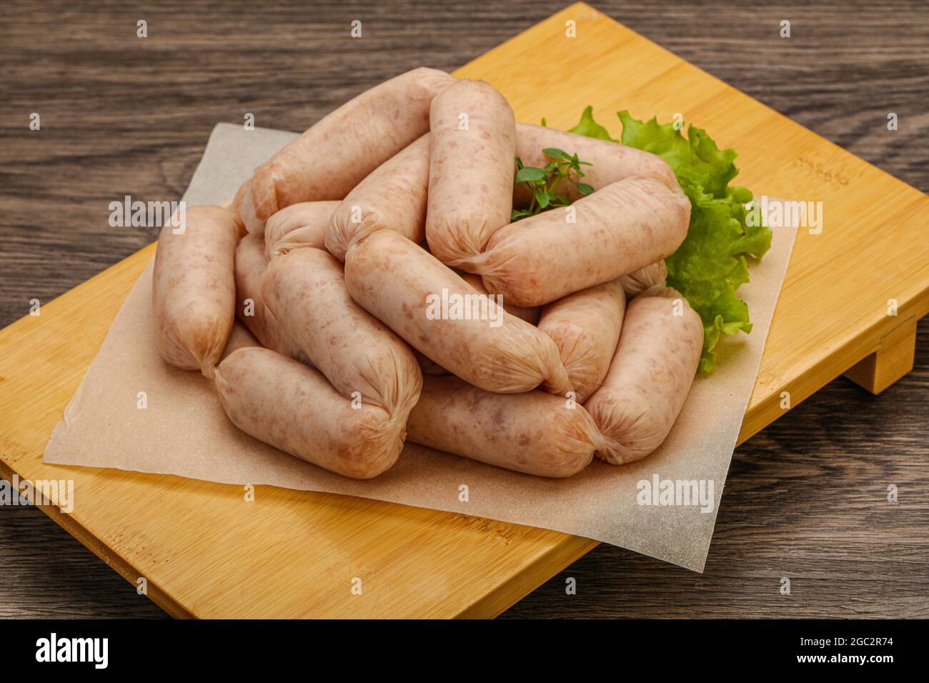Raw natural chicken baby sausages for roast Stock Photo - Alamy
