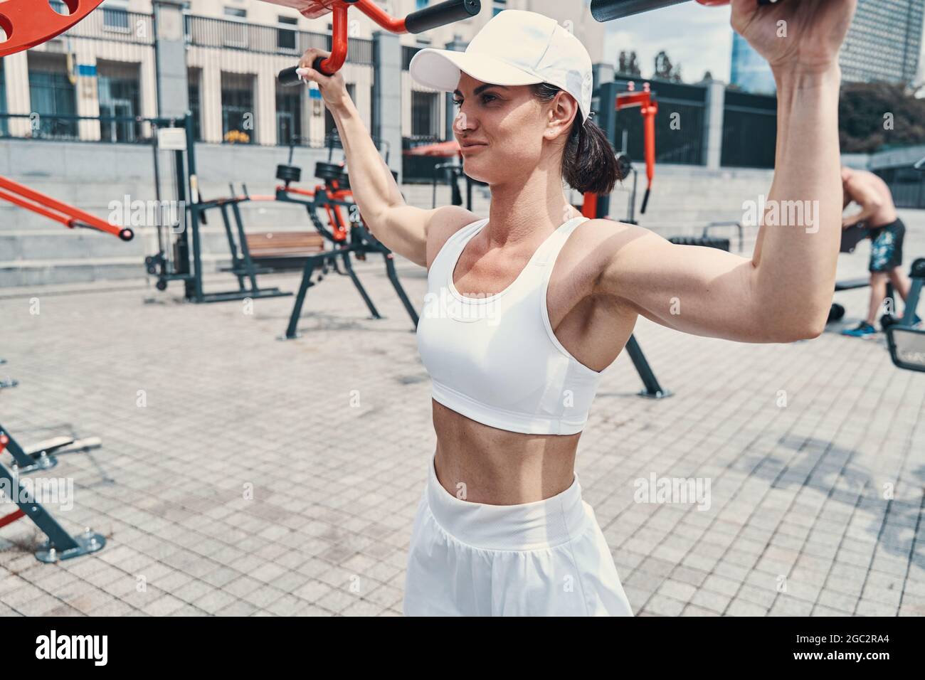 Female taking handles of cable lat pull-down Stock Photo - Alamy