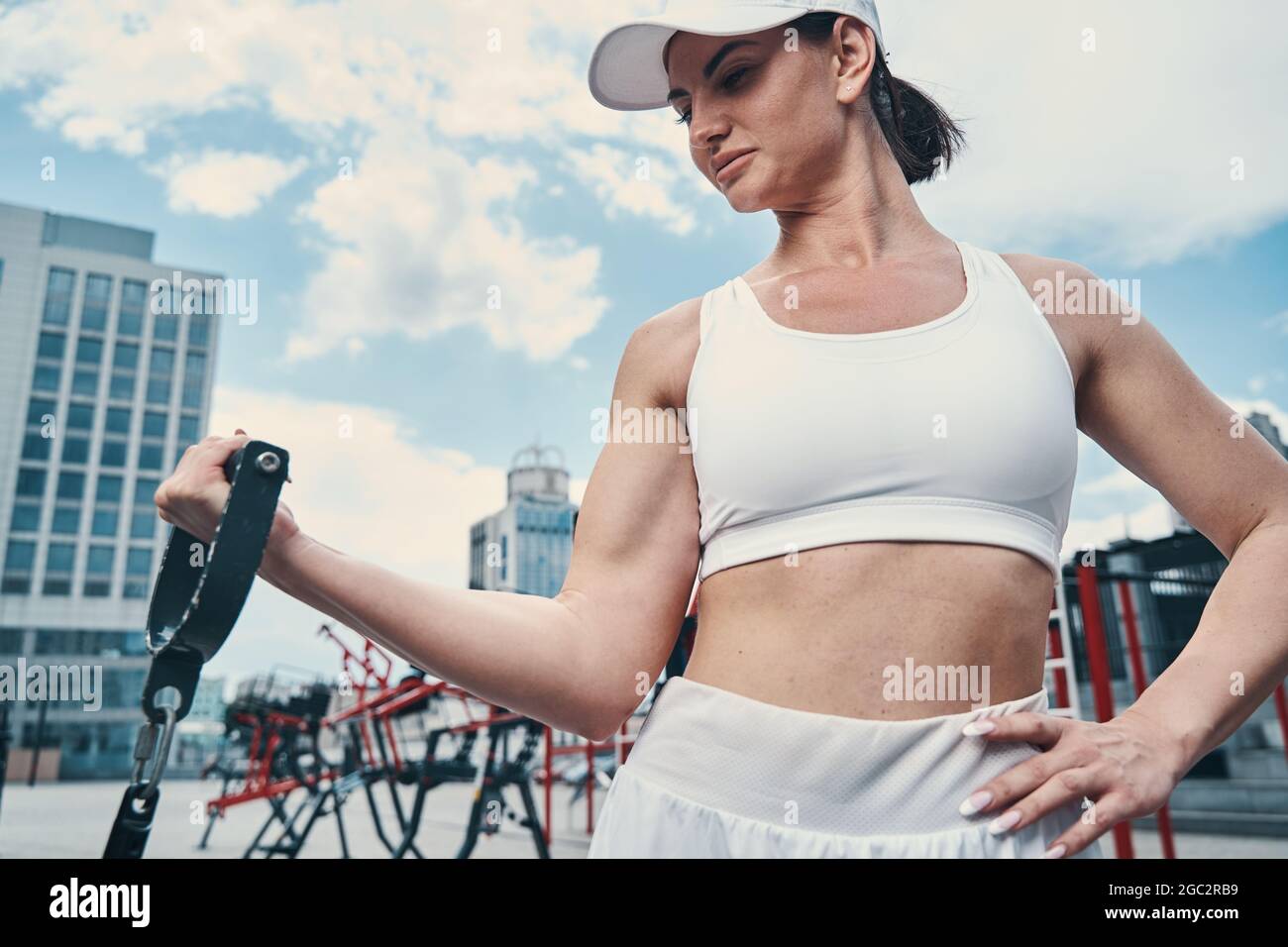 Adult raising weight on rope with right hand Stock Photo - Alamy