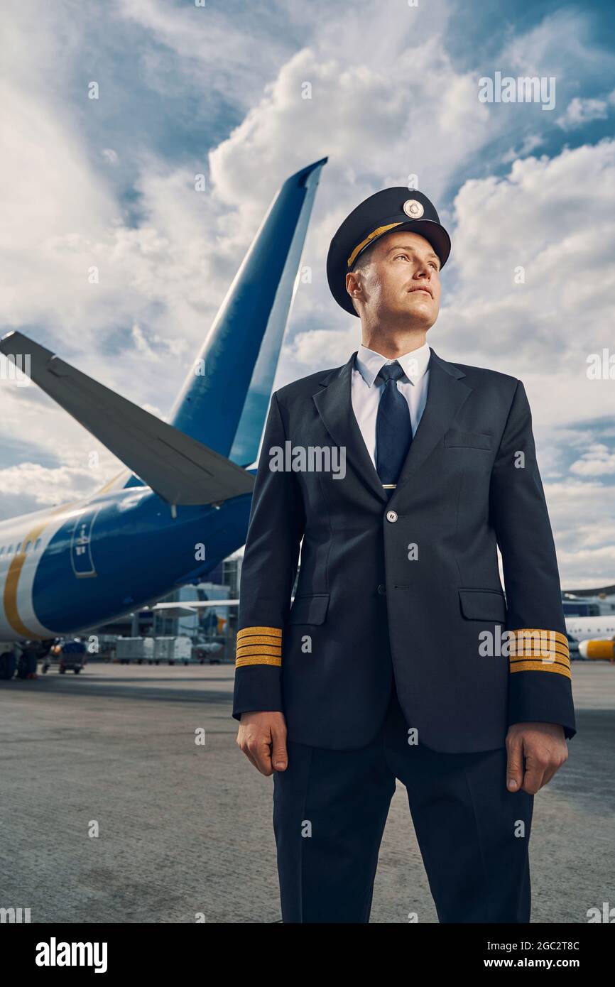 Attractive professional aviator dressed in uniform looking away Stock ...