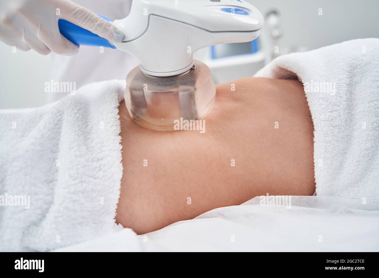 Beautician using vacuum tool for lady belly Stock Photo - Alamy