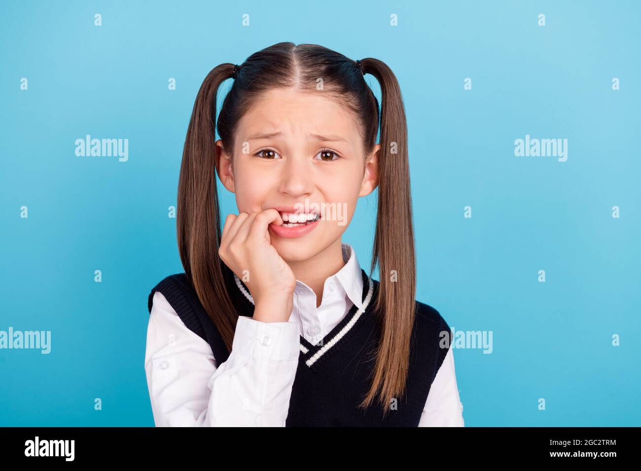 Photo of sad small brunet girl bite fingers wear white shirt vest ...