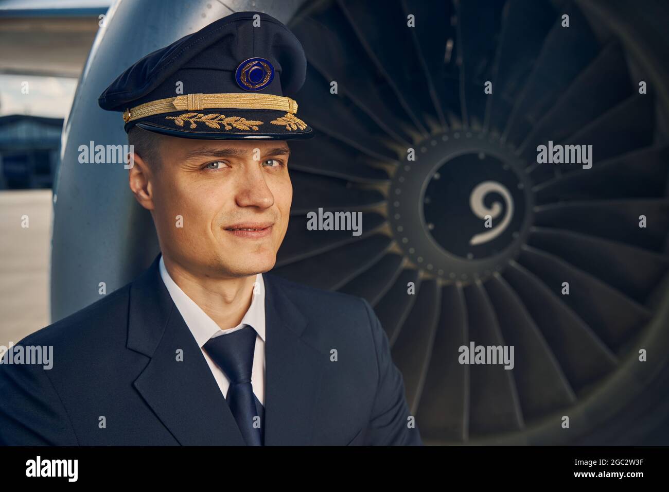 Good-looking male pilot standing by an aeroengine Stock Photo - Alamy