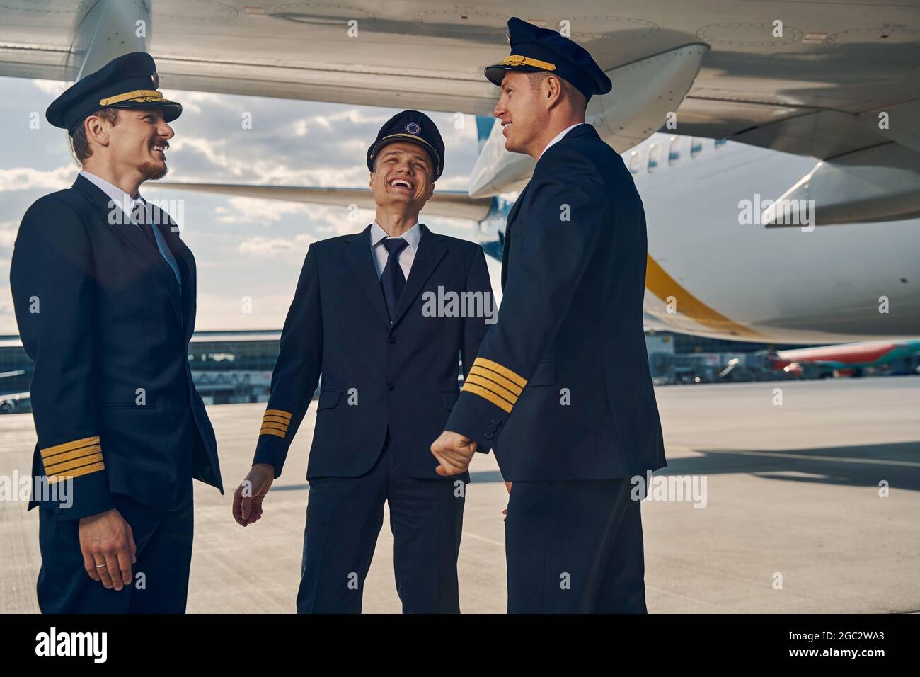Three airline pilots enjoying each other company Stock Photo - Alamy