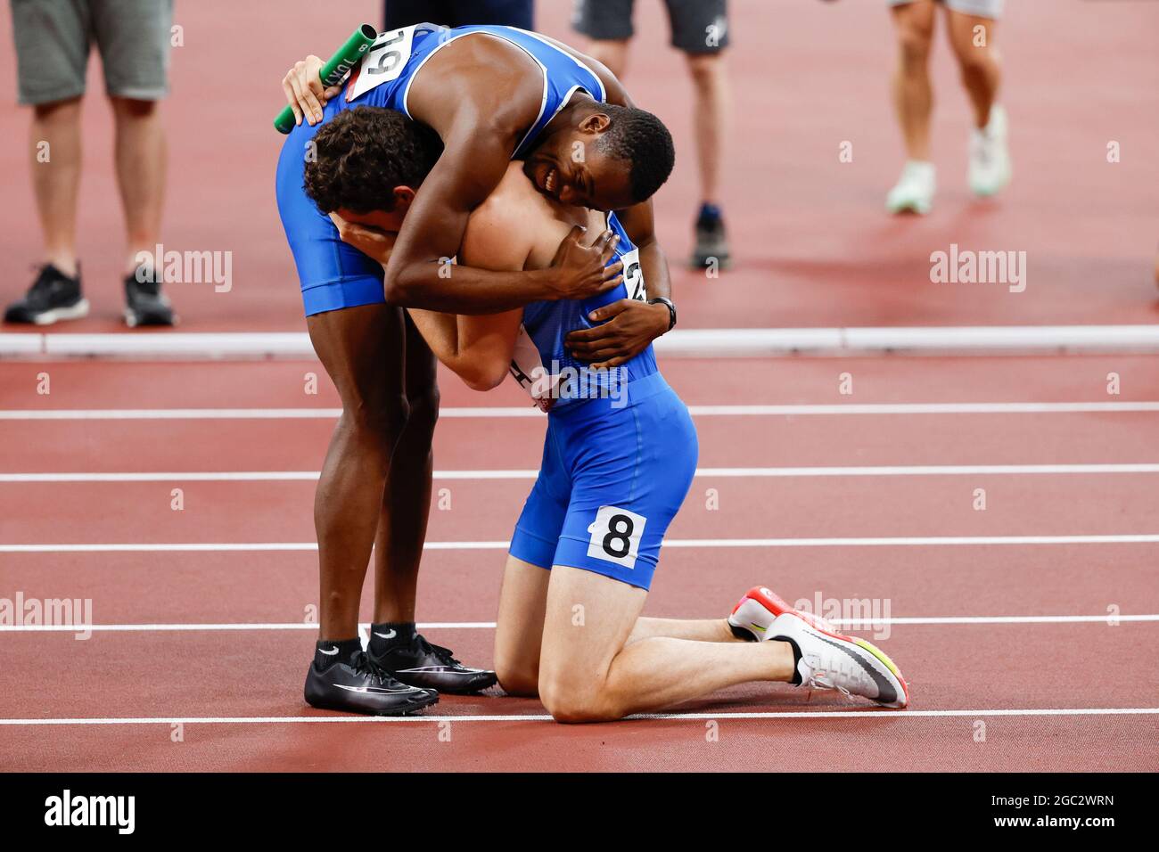 Tokyo, Japan. 06th Aug, 2021. Italy's Filippo Tortu (R) gets a hug from ...
