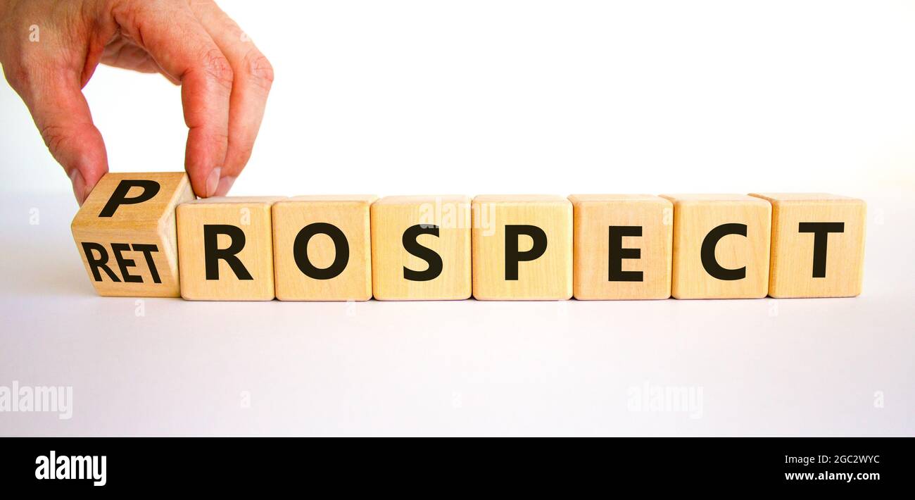 Prospect or retrospect symbol. Businessman turns a cube and changes the ...