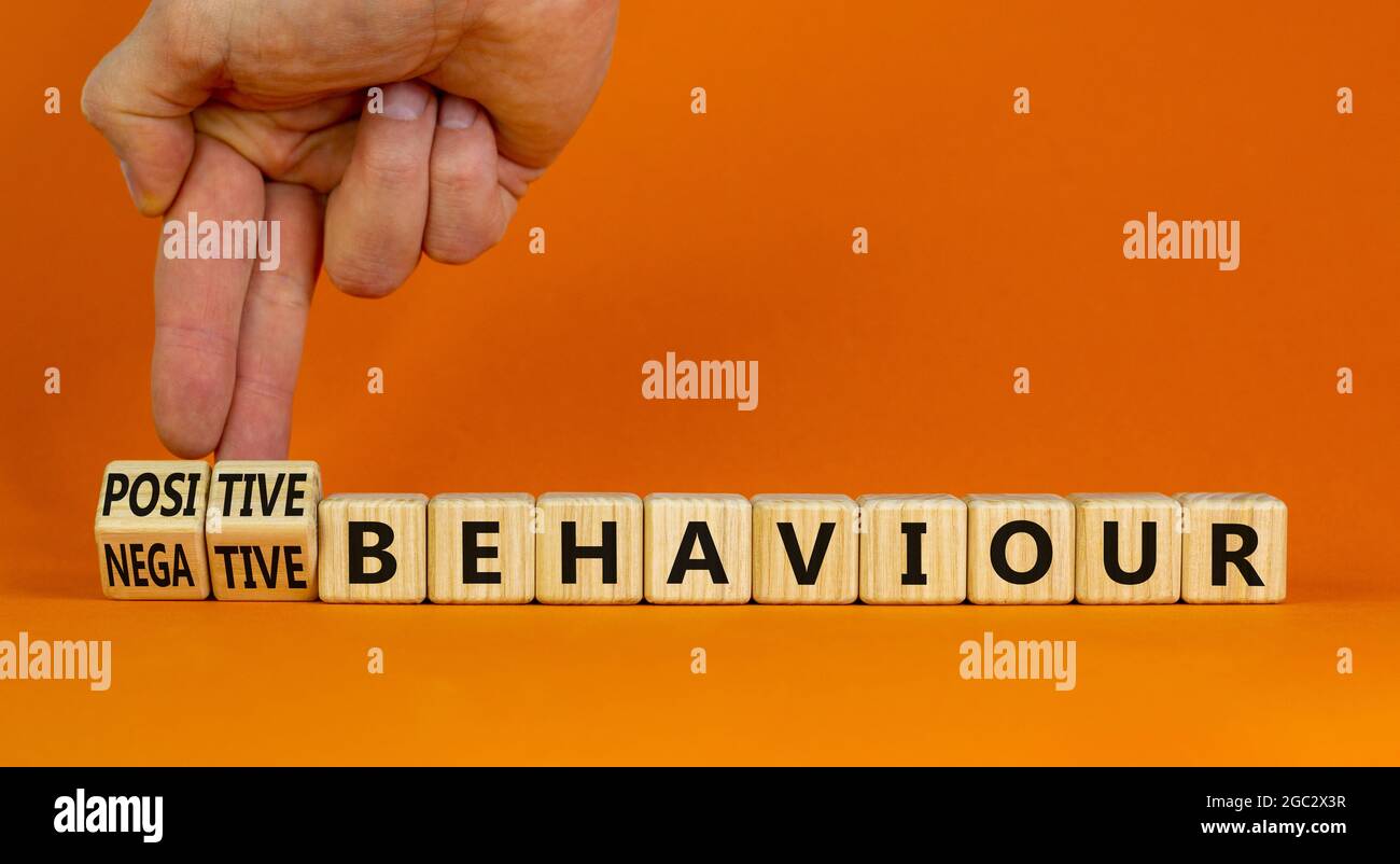 Positive or negative behaviour symbol. Businessman turns cubes, changes ...