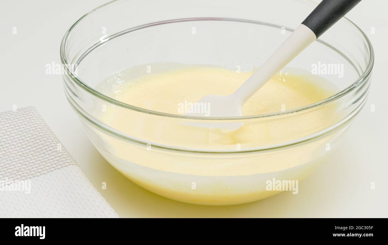 Cake batter close up in a glass bowl. Step by step baking process ...
