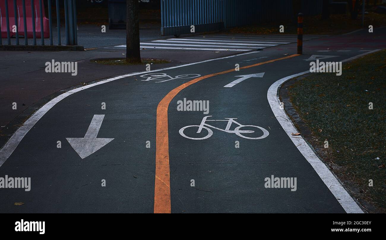 Road with white bicycle sign and painted lines on it Stock Photo - Alamy