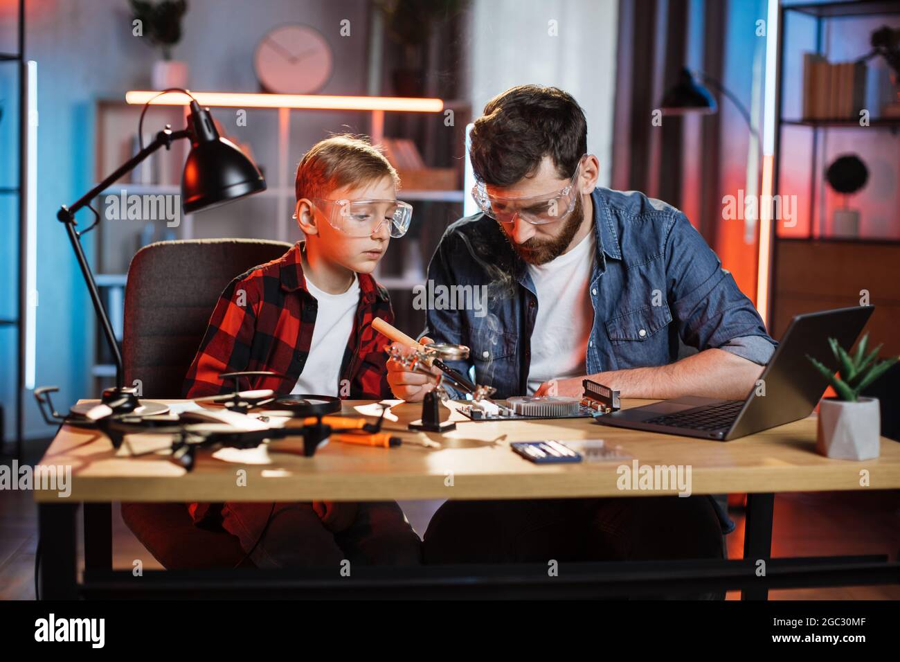Father son fixing table hi-res stock photography and images - Alamy