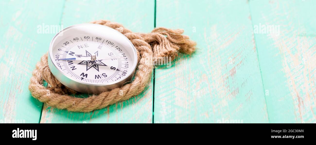 Compass and rope on wooden texture background Stock Photo - Alamy