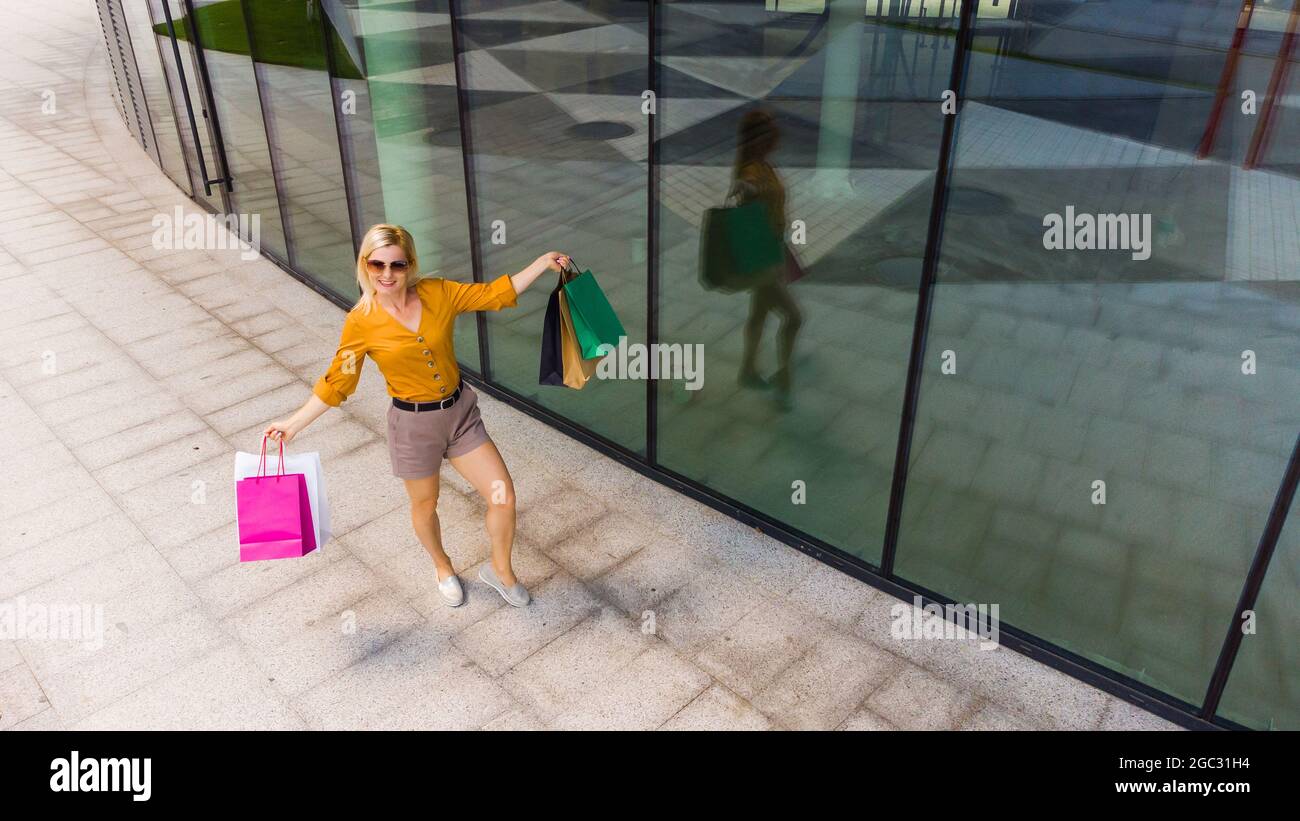 happiness, consumerism, sale and people concept - smiling young woman ...
