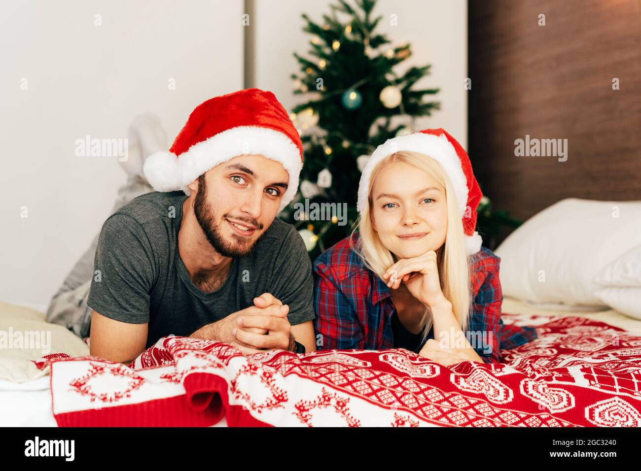 Portrait of a young couple in love in christmas hats Stock Photo - Alamy