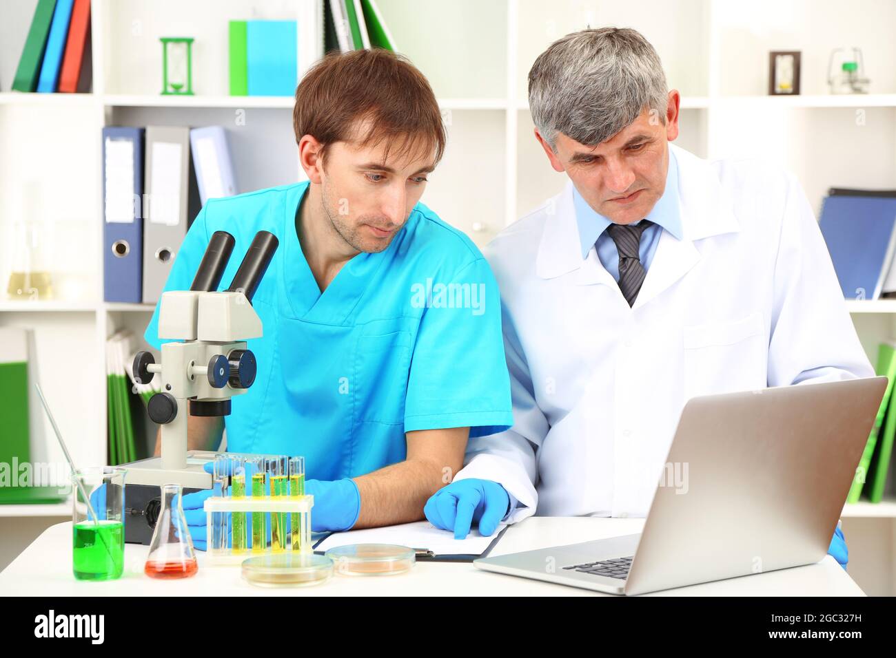 Physician and assayer during research on room background Stock Photo ...