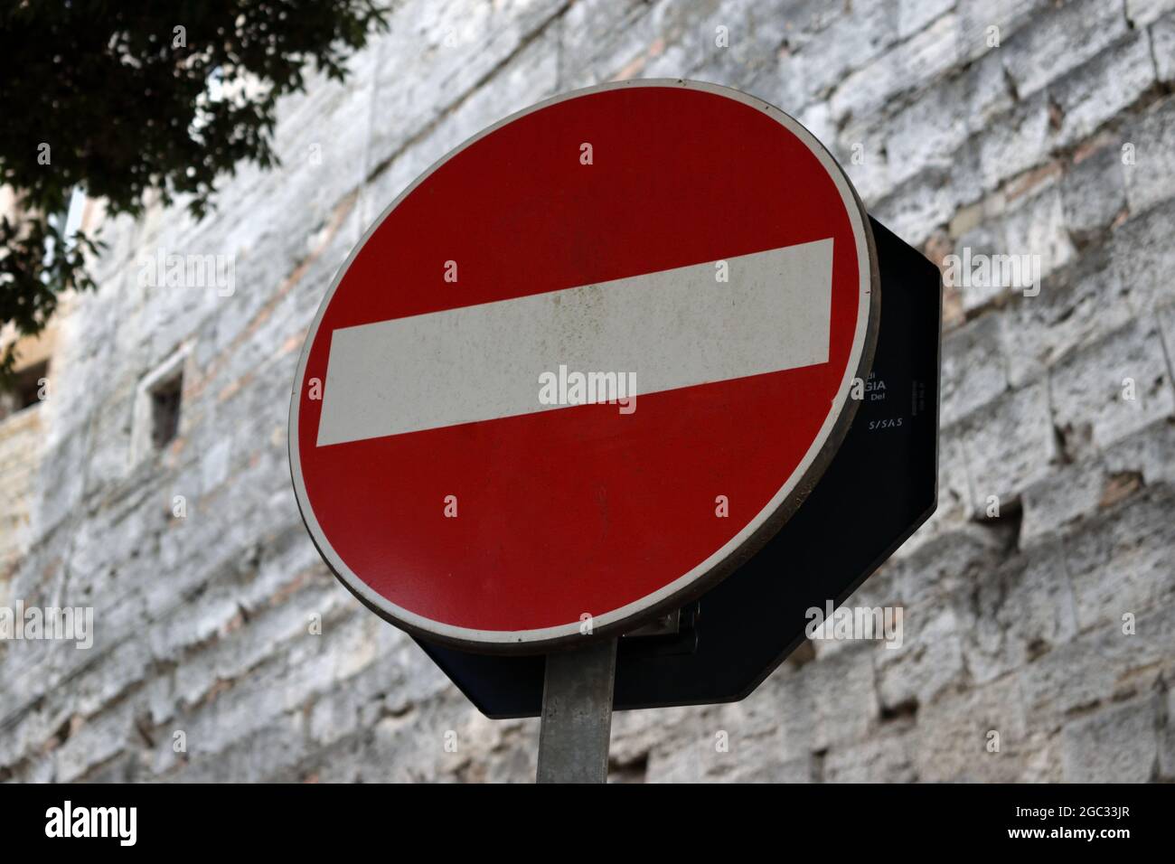 One red no entry traffic sign . The sign is hanging on a metal base ...