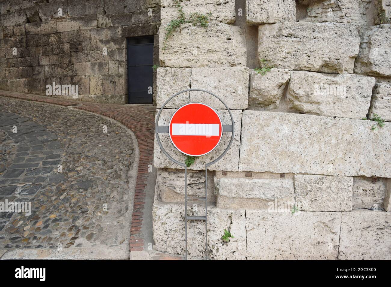 One red no entry traffic sign . The sign is hanging on a metal base ...