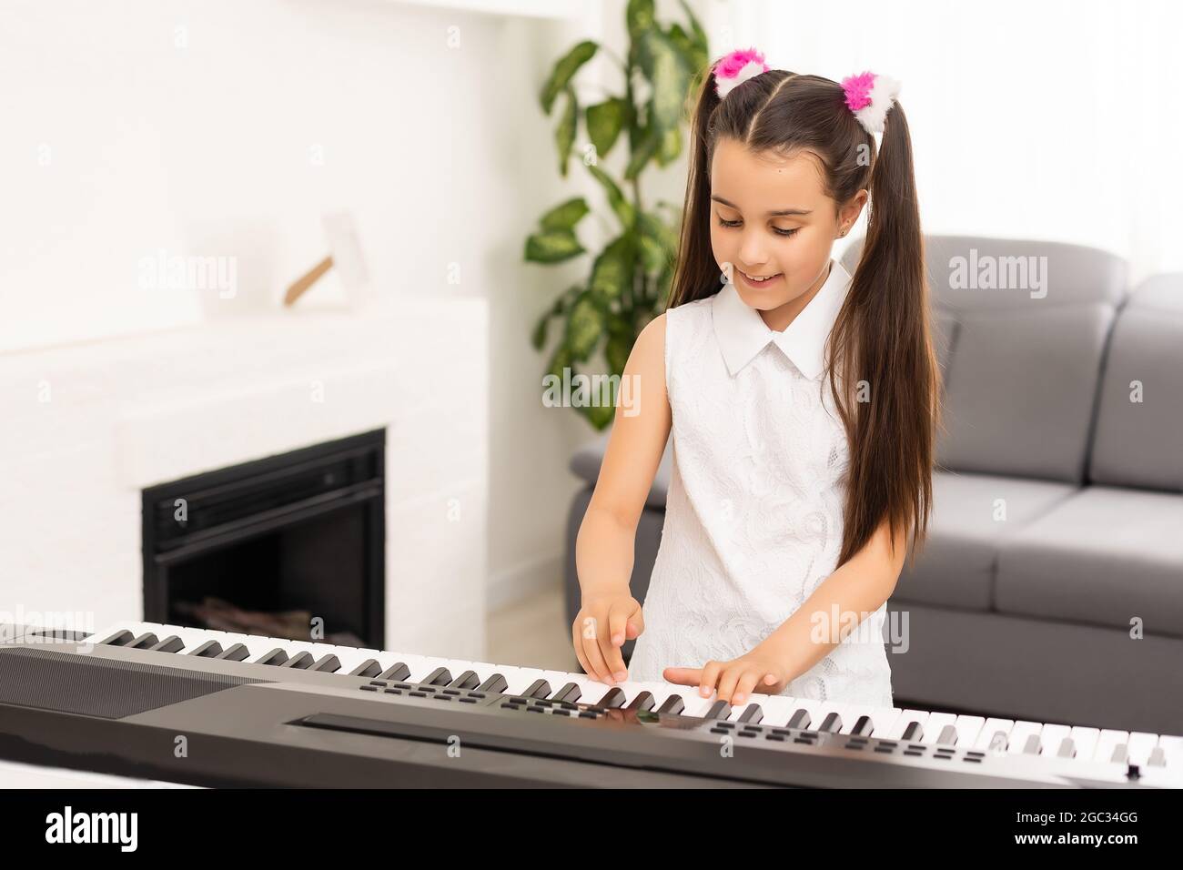beautiful girl sings while playing on an electronic piano Stock Photo ...