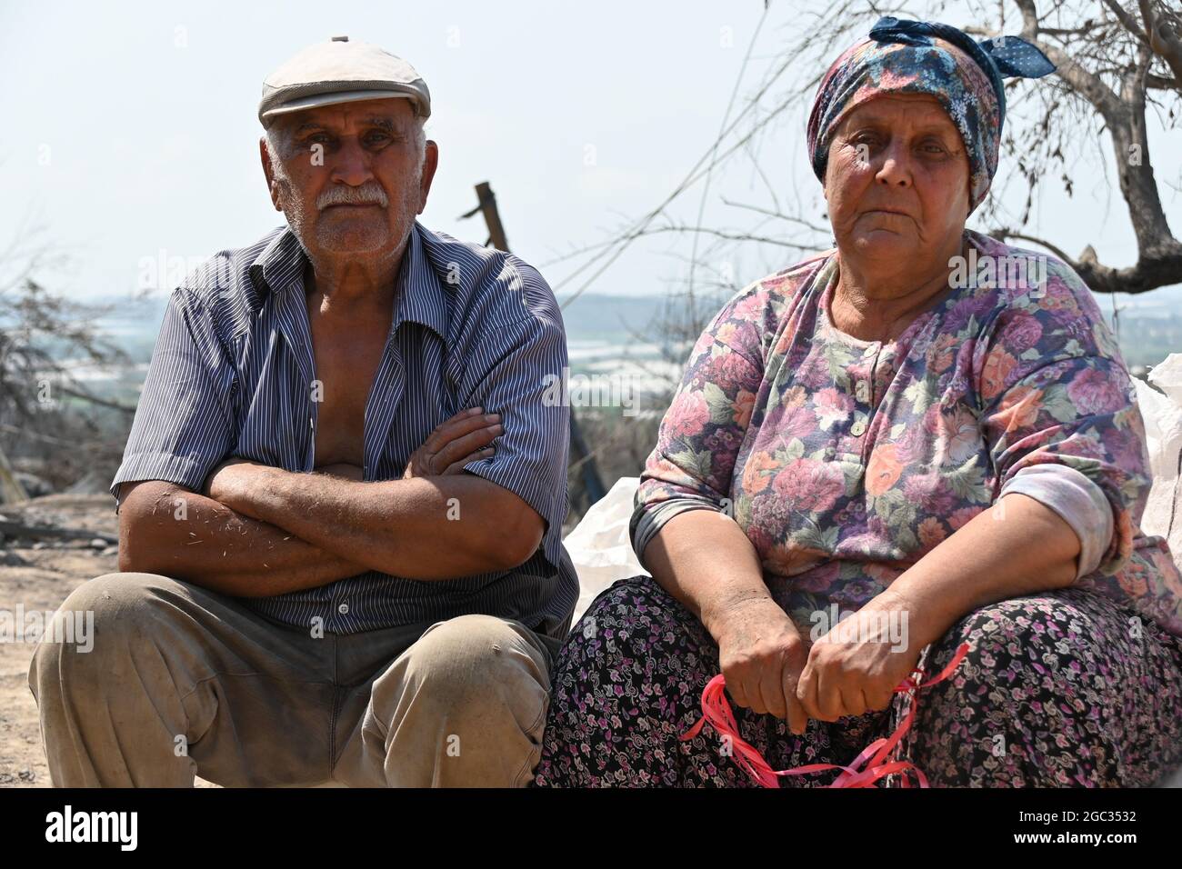Kalemler, Turkey. 06th Aug, 2021. The Catal couple sits in front of ...