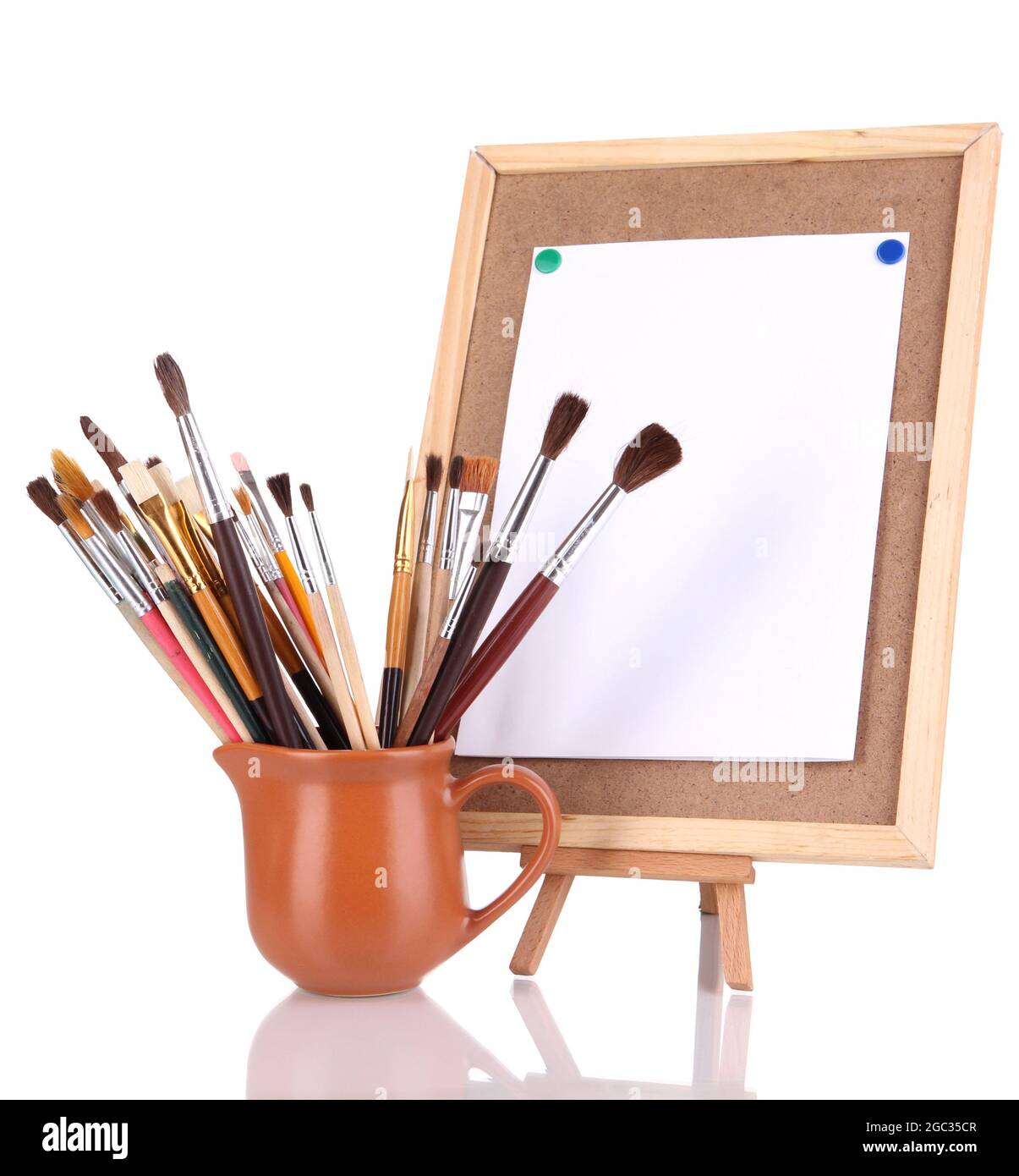 Small easel with sheet of paper and art supplies isolated on white ...