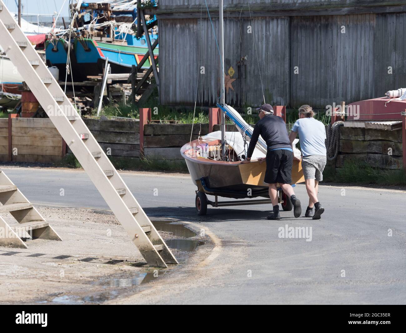 Men pushing a boat hi-res stock photography and images - Alamy