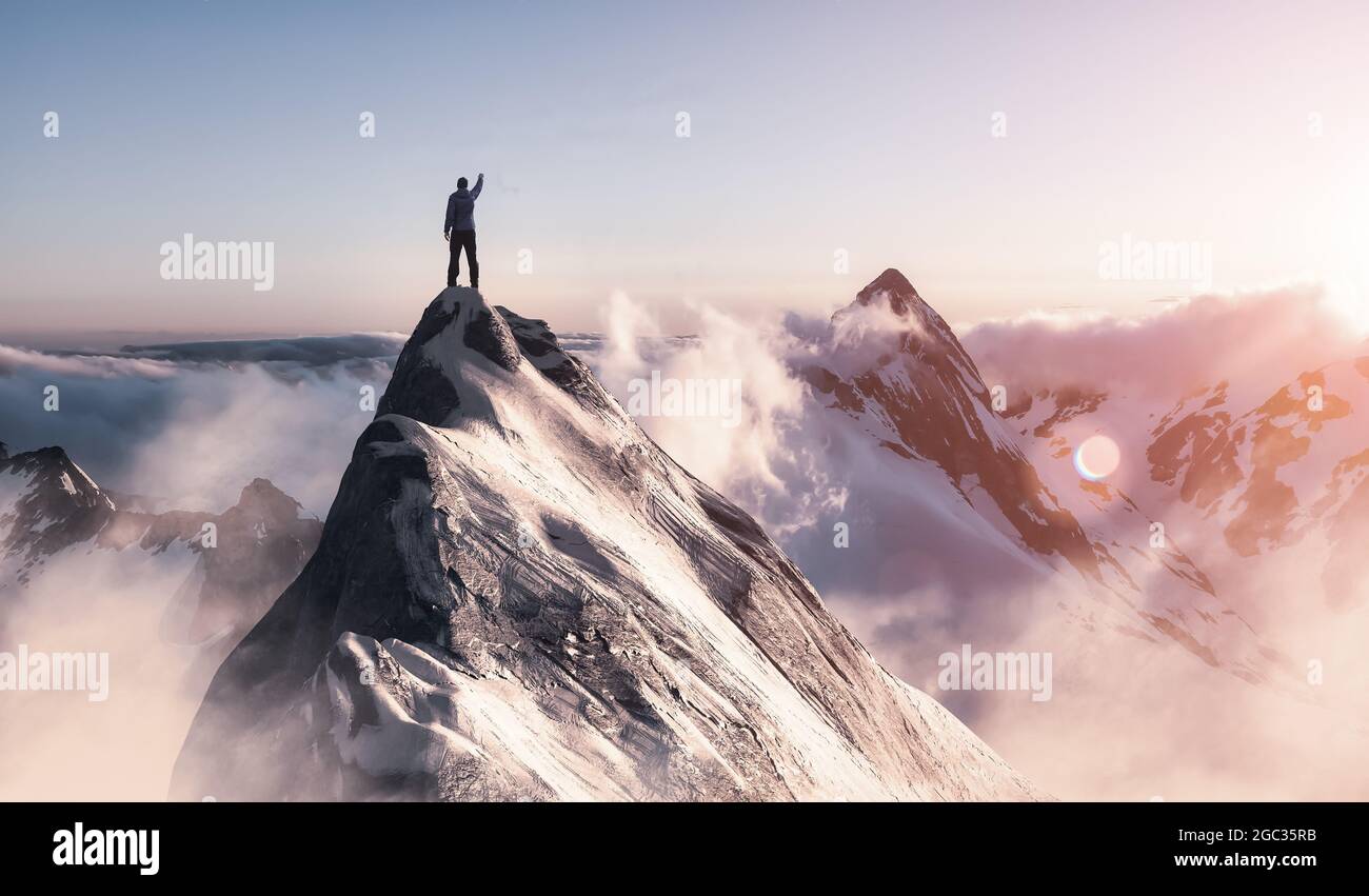 Adventurous Man is taking in the moment on top of a mountain Stock ...