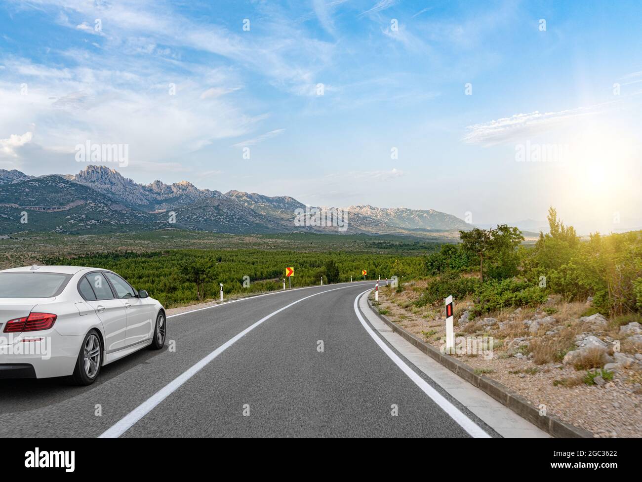 Car is driving along the road. White car on a suburban highway Stock ...