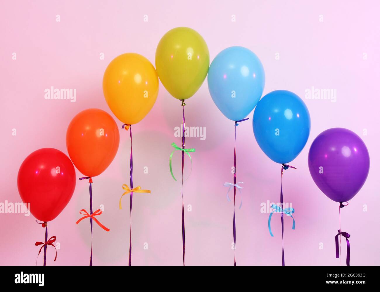 Rainbow of balloons on light background Stock Photo - Alamy