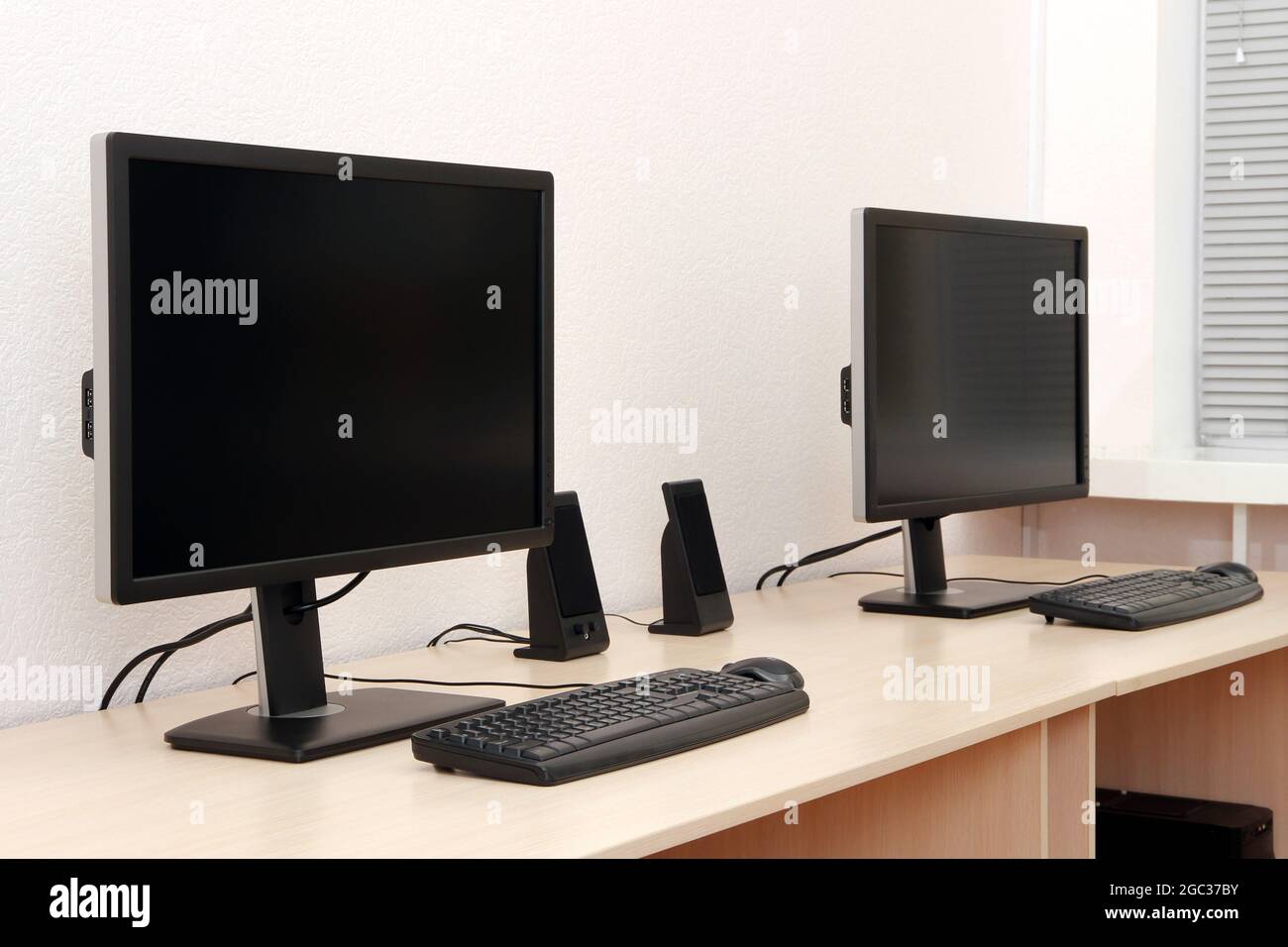 Computers on tables in room Stock Photo - Alamy