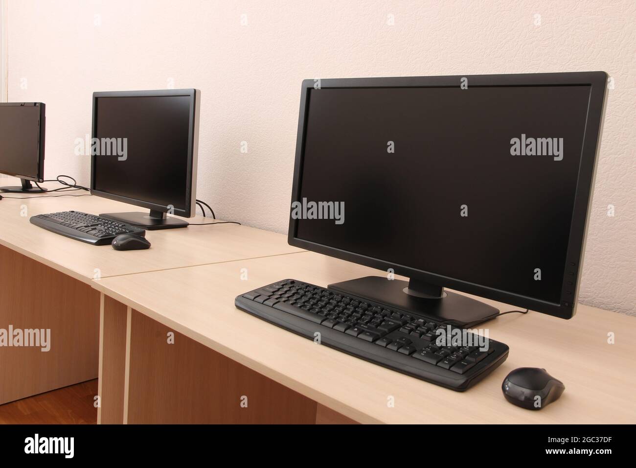Computers on tables in room Stock Photo - Alamy