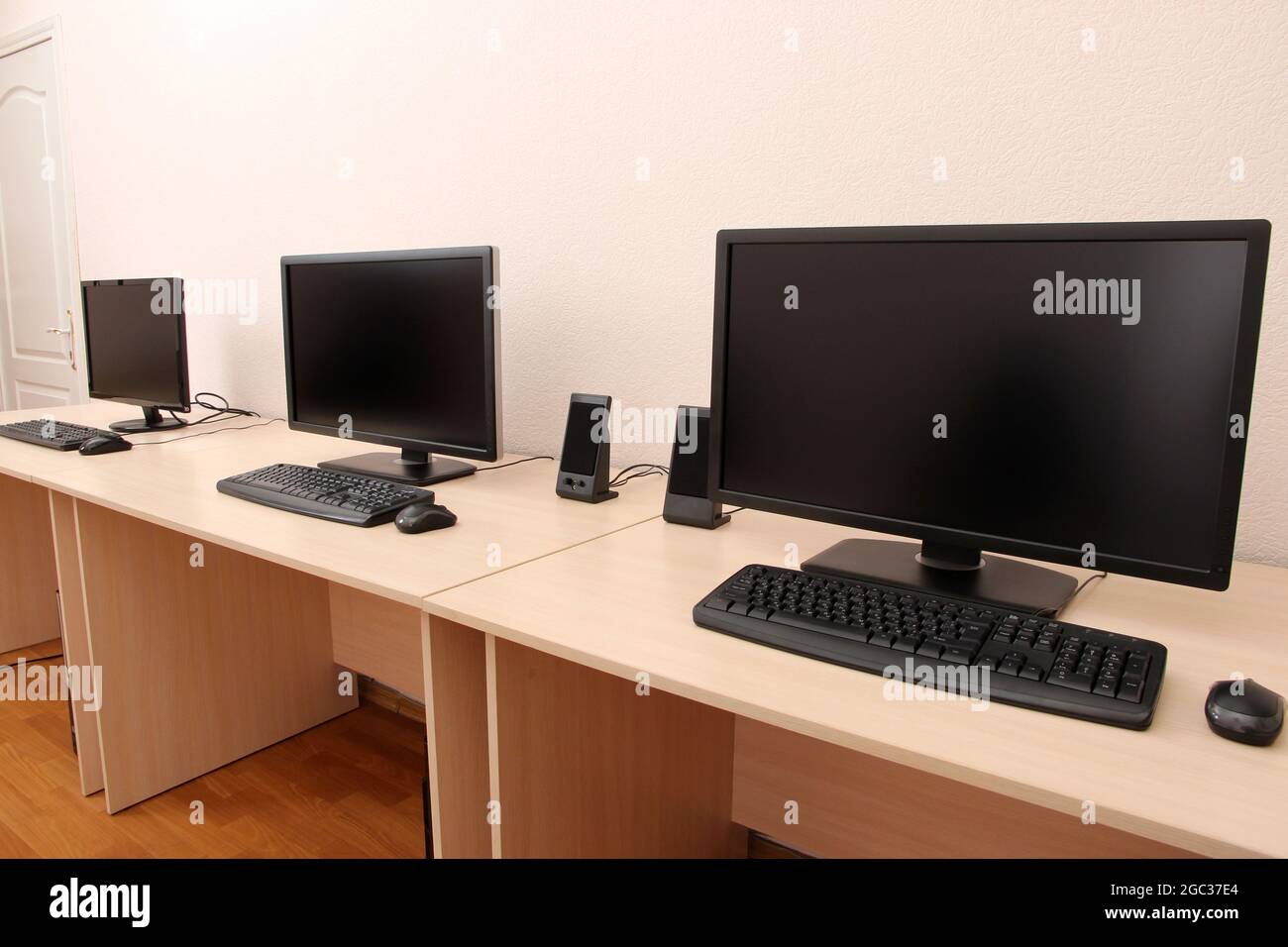 Computers on tables in room Stock Photo - Alamy