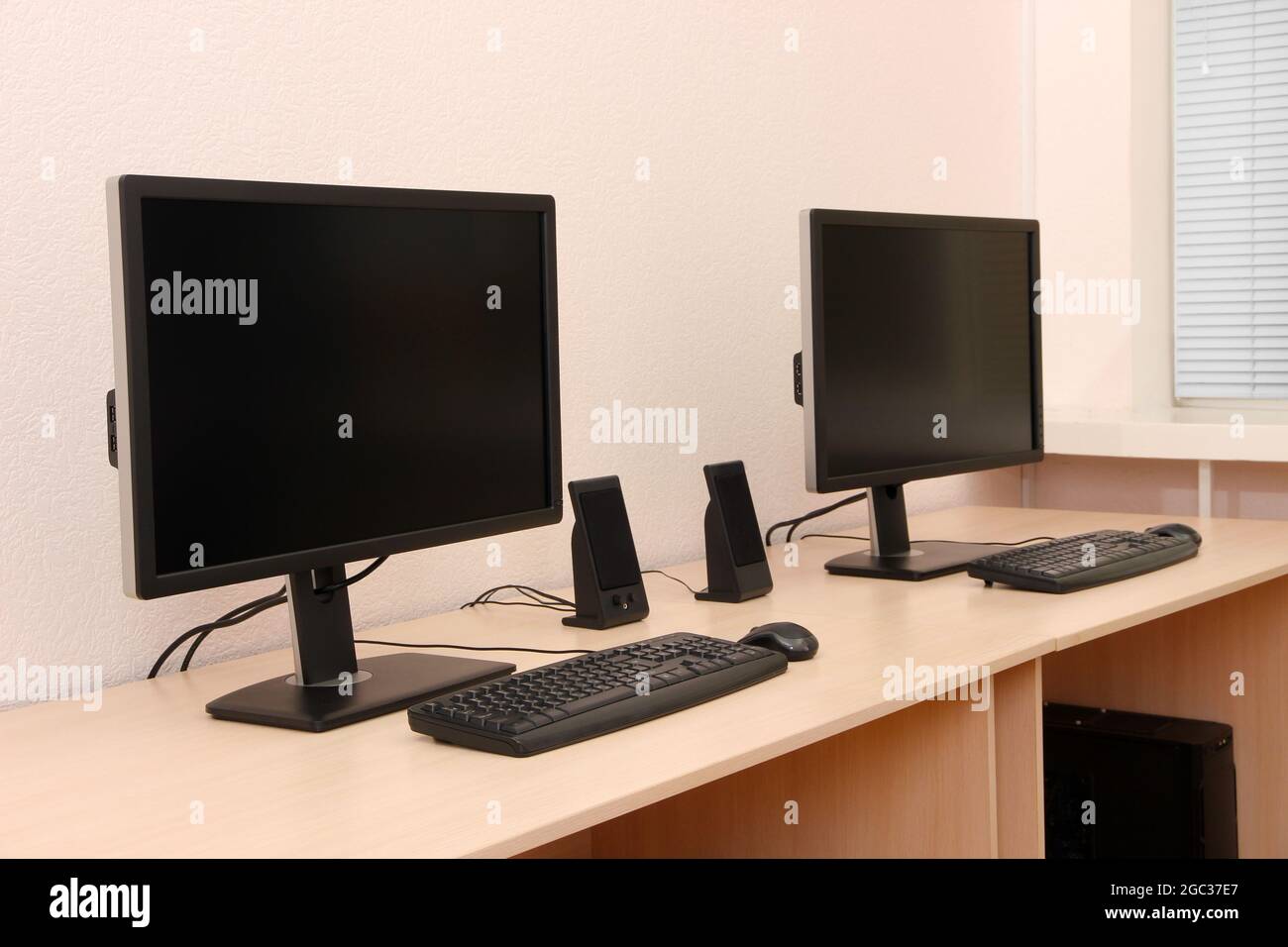 Computers on tables in room Stock Photo - Alamy
