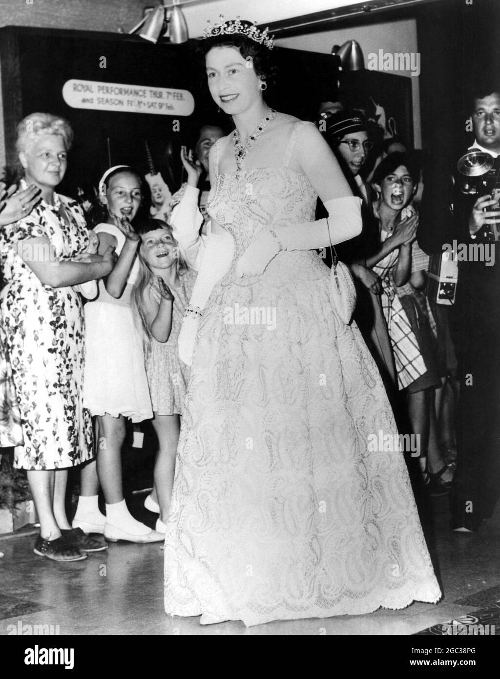 Queen Elizabeth waves to the crowd as she leaves St James Theatre in ...