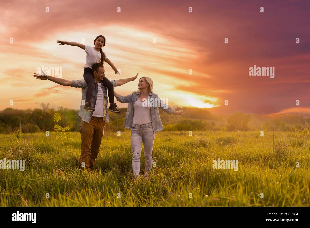 Happy family: mother father and child daughter on nature on sunset ...