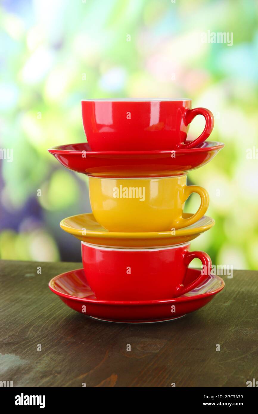 Three cups on nature background Stock Photo - Alamy