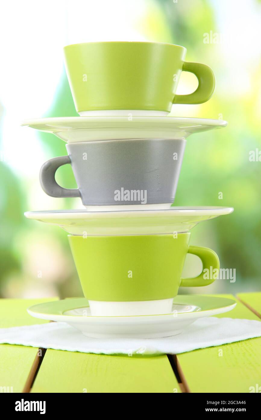 Three cups on nature background Stock Photo - Alamy