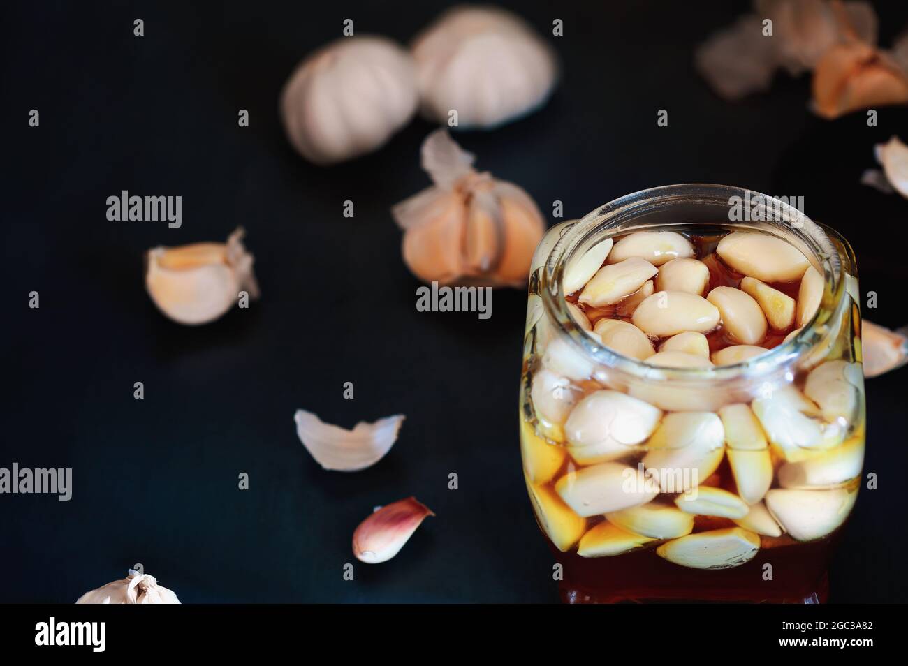 Fermented garlic cloves in a jar of honey, a rich source of probiotics ...