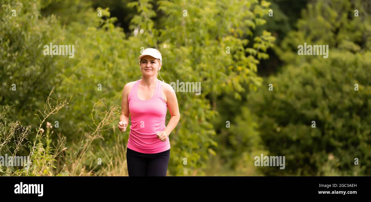 Young lady running on a rural road Stock Photo - Alamy