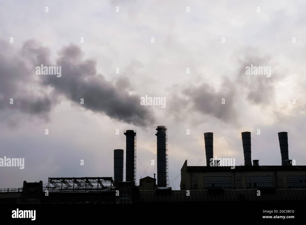 Factory smokestack emitting smoke against sky - environmental pollution ...
