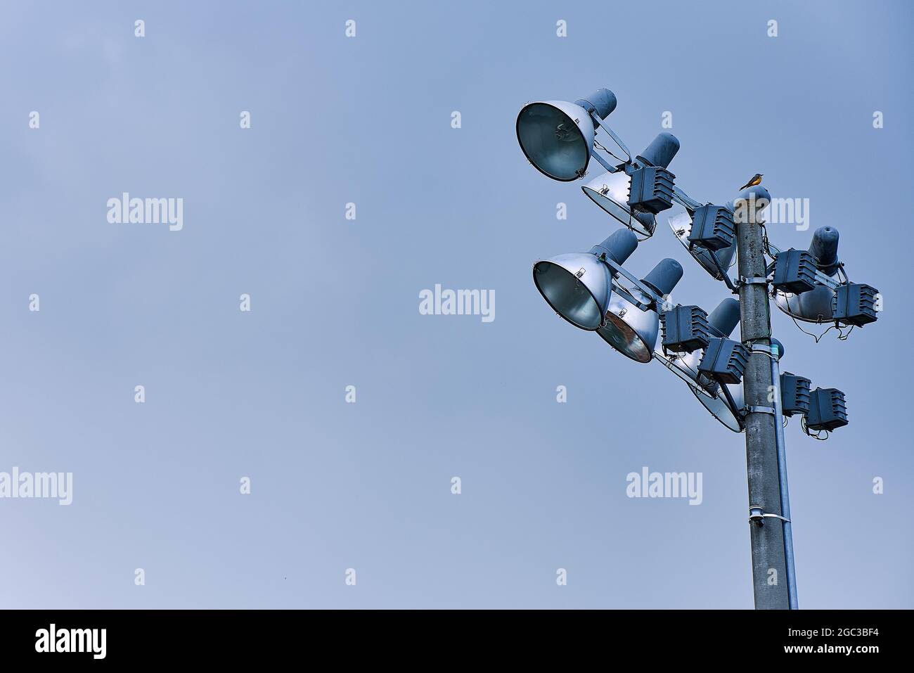 Spotlight on a column with many lamps on it on a cloudy day Stock Photo ...