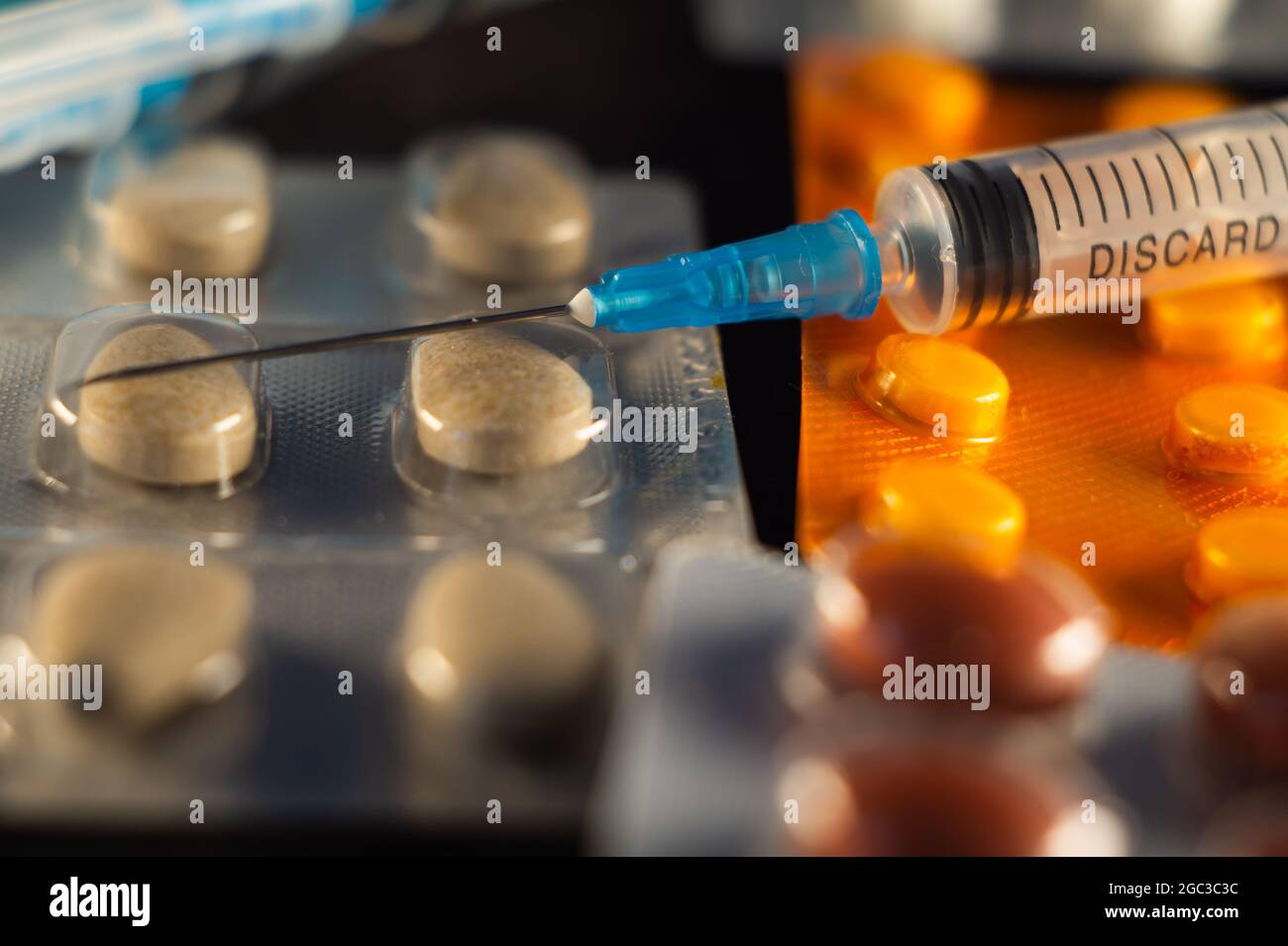 Closeup shot of pharmaceutical capsules, pills and syringes Stock Photo ...