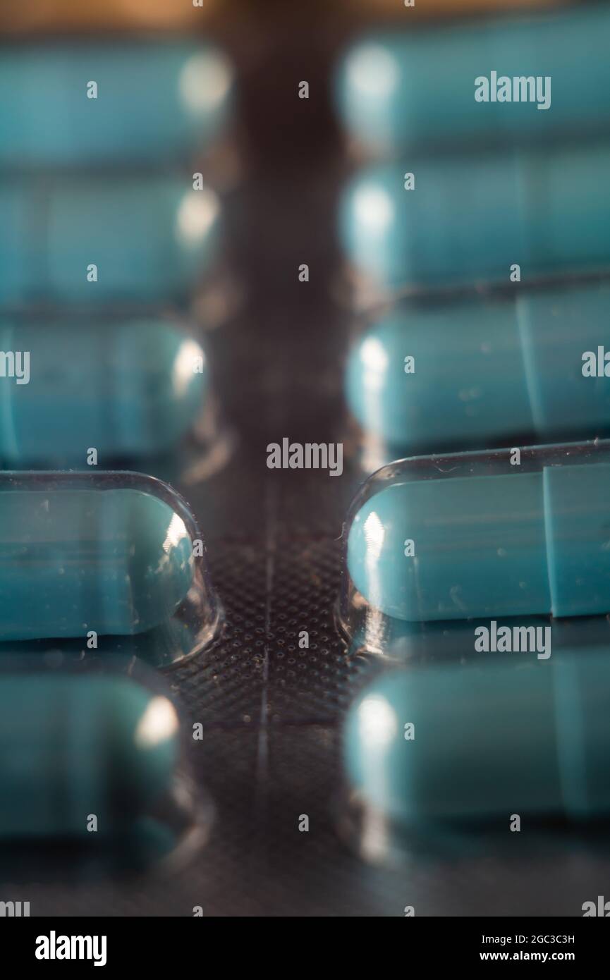 Vertical shot of blue pharmaceutical capsules Stock Photo - Alamy